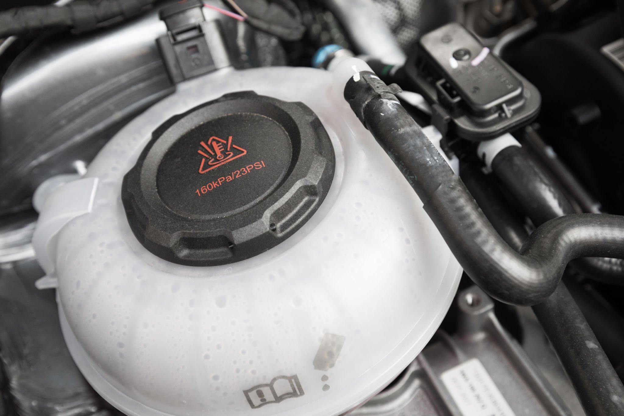 How long to wait before adding coolant to hot engine?